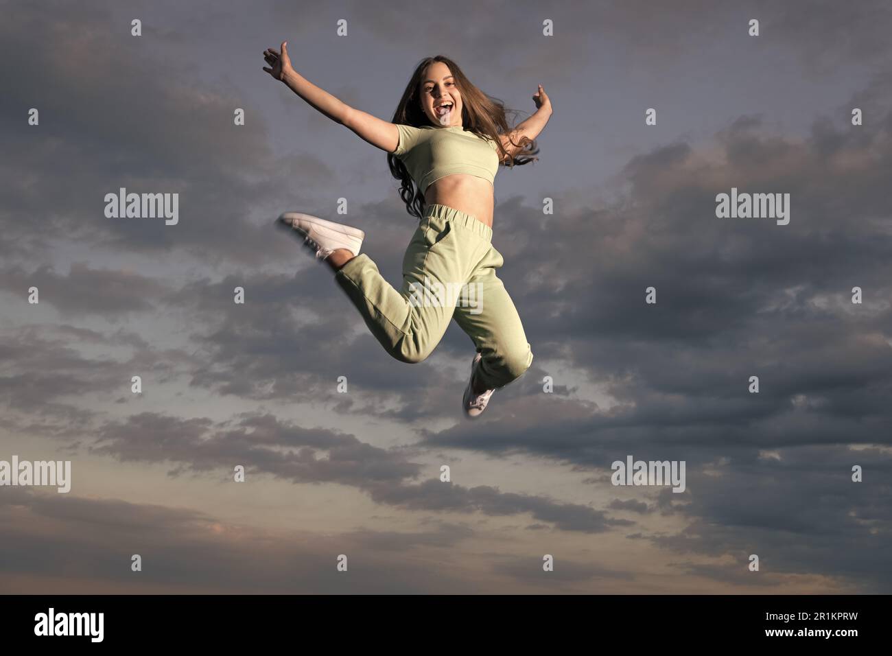 happy teen girl jumping high on sky background Stock Photo - Alamy