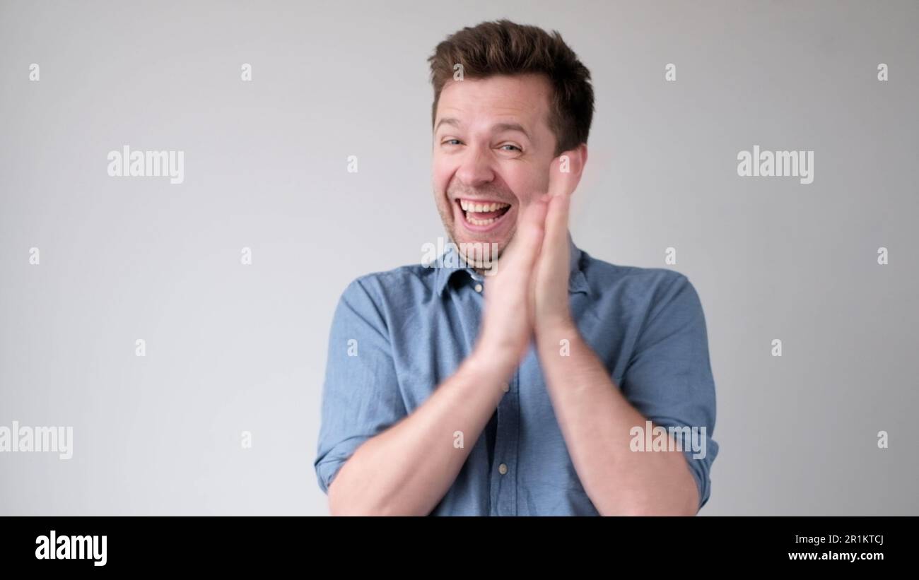 European young man applauds, praising someone for their work Stock ...