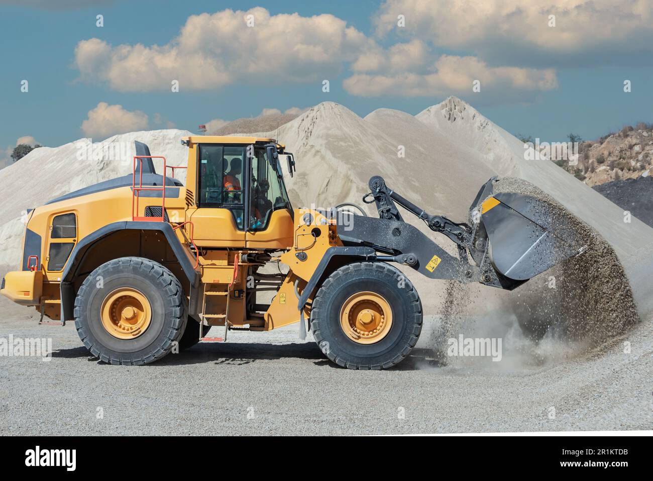 Wheel loaders moving sand in a quarry.Close-up Stock Photo - Alamy