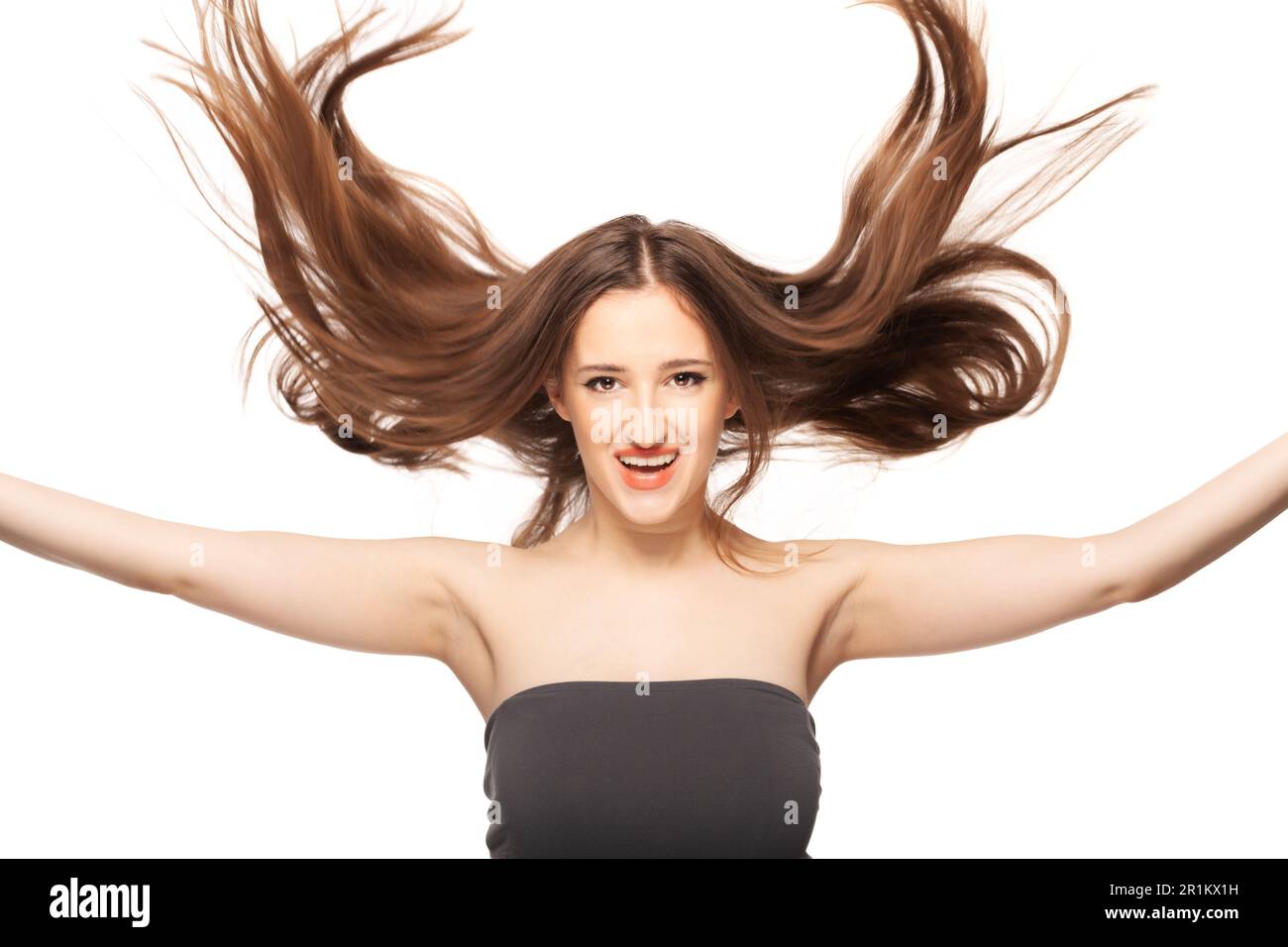 Beautiful girl close studio portrait against white background. Throwing ...