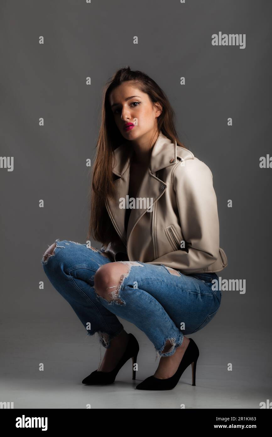 full body poirtrait of a beautiful girl with long hair wearing jeans ...