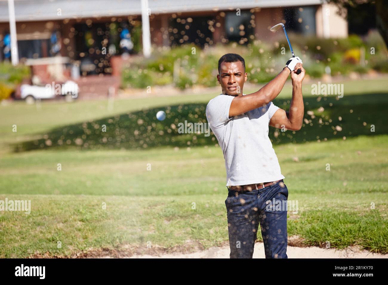 Perfect shot. a handsome young man playing a game of golf Stock Photo ...