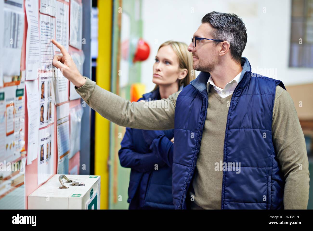 Checking the weekly work updates. a two coworkers managing a warehouse ...