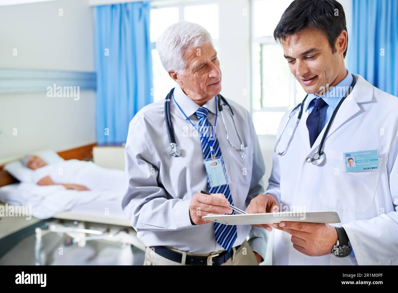 Getting a little guidance. two doctors discussing a case file with ...
