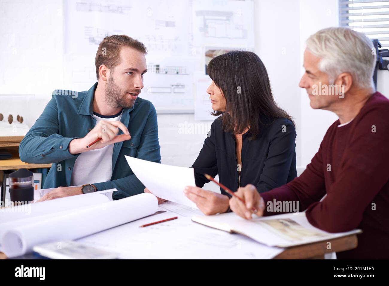 Sharing ideas and opinions. three architects working on a new building ...