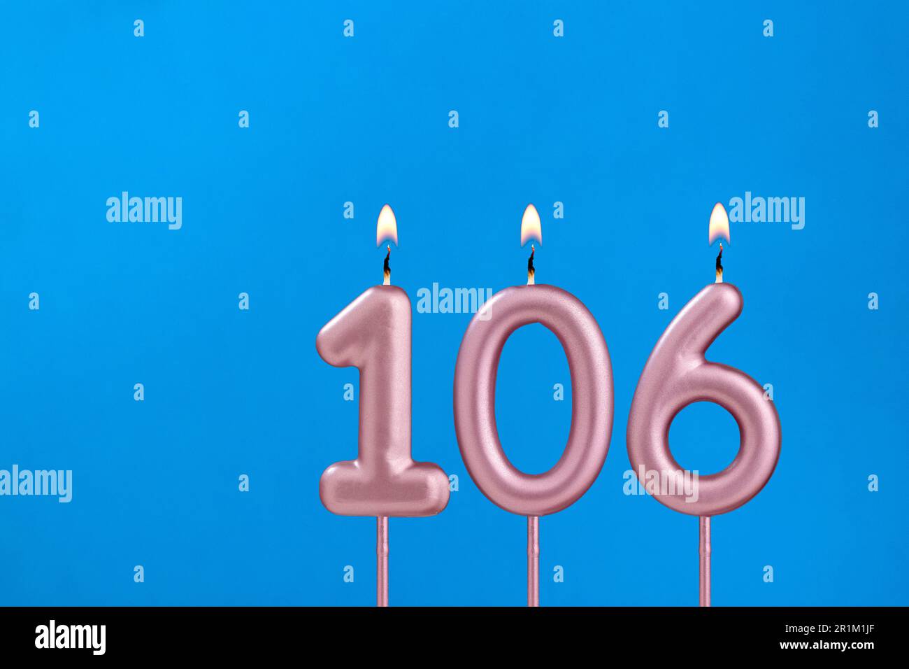 Candle number 106 - Birthday in blues foamy background Stock Photo - Alamy