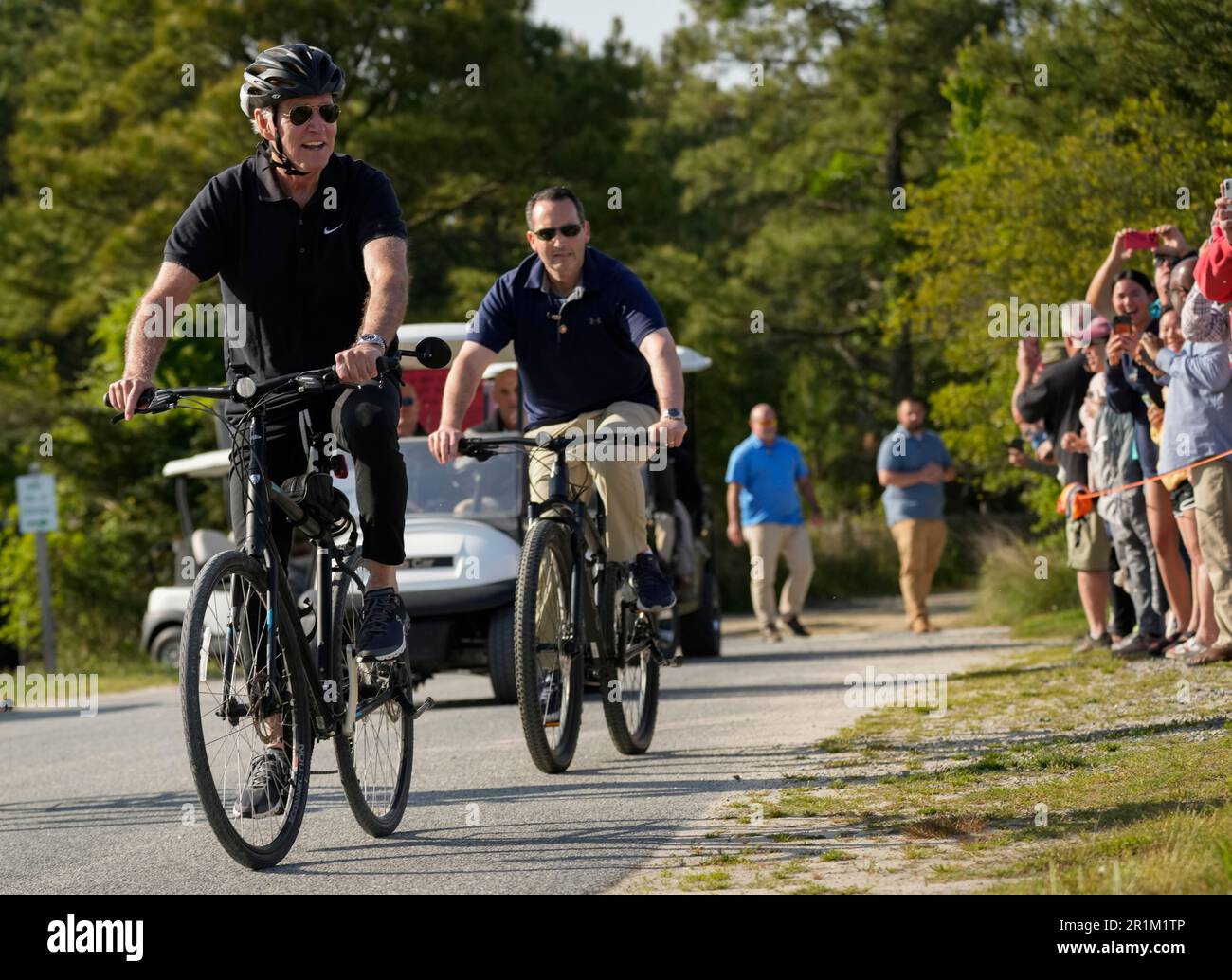 President Joe Biden looks to people gathered along the path as he goes ...