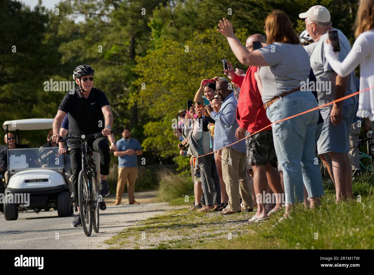 President Joe Biden looks to people gathered along the path as he goes ...
