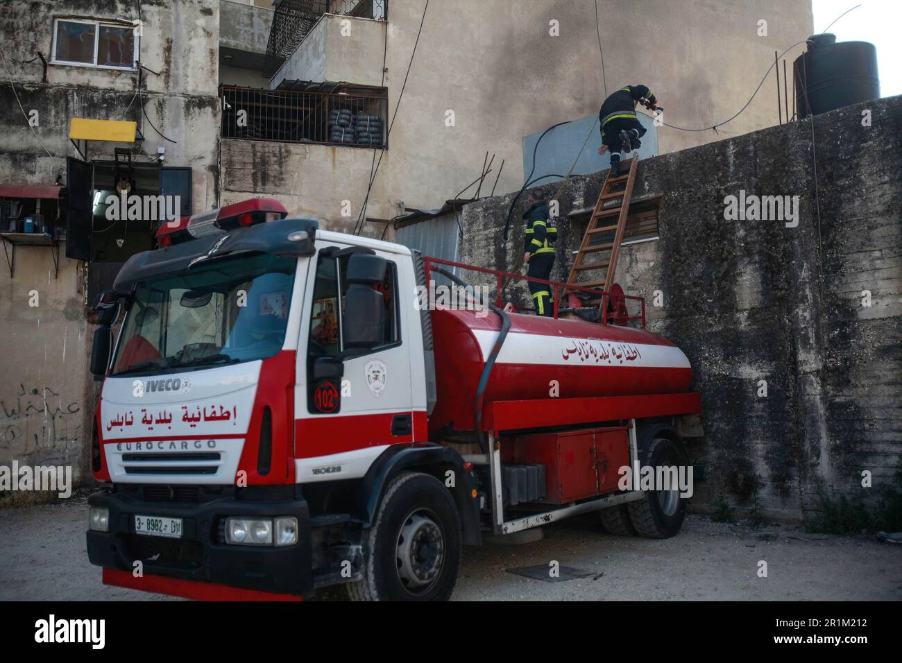 Nablus, Palestine. 14th May, 2023. Palestinian firefighters extinguish ...
