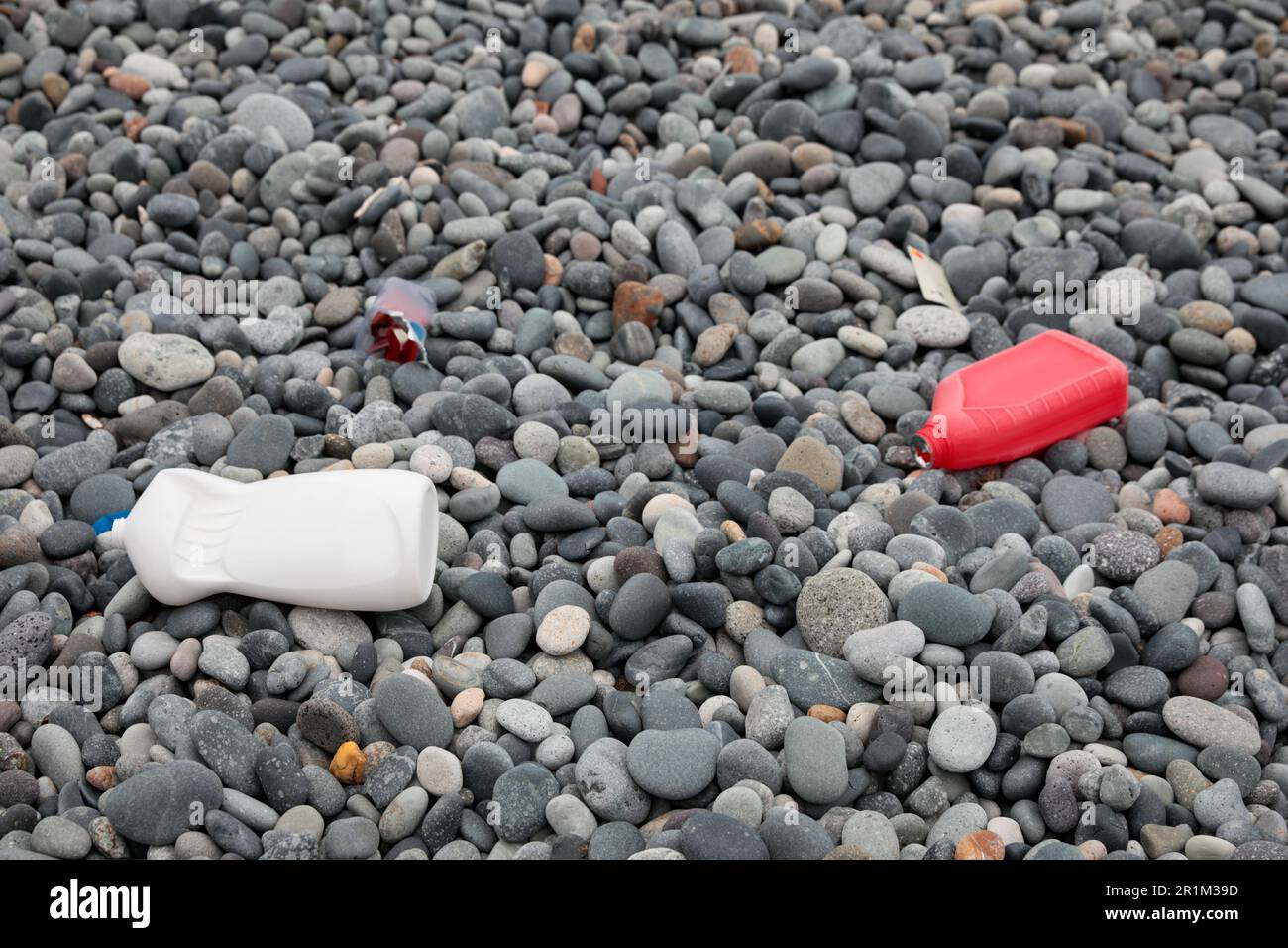 Plastic bottles thrown out on pebble coast Stock Photo - Alamy