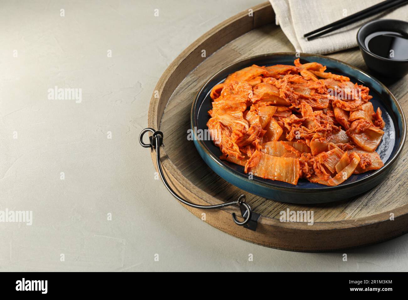 Delicious kimchi with Chinese cabbage and sauce on light grey table ...