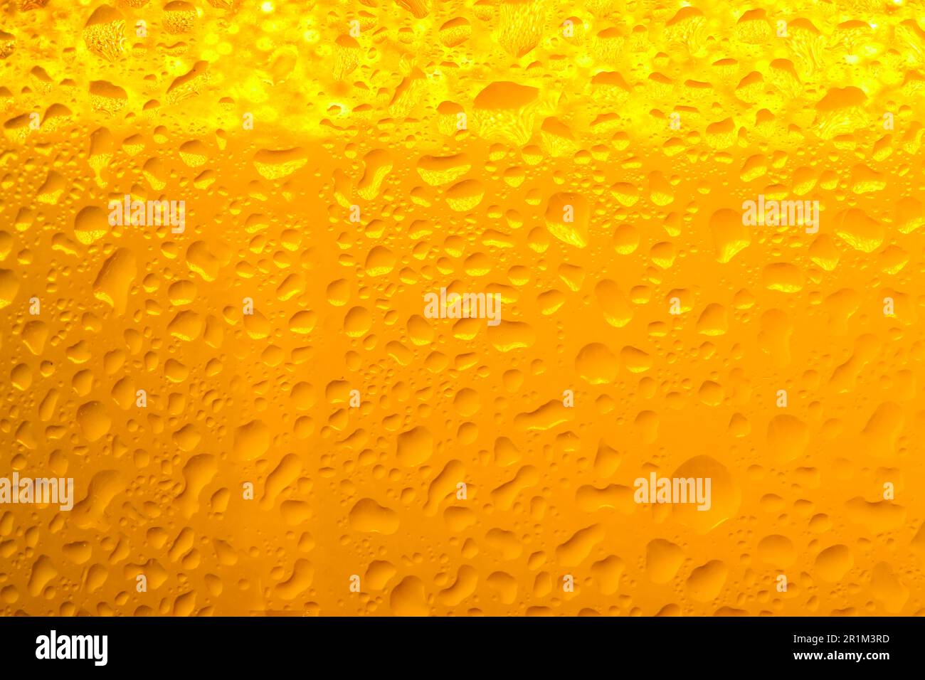 Glass of tasty cold beer with condensation drops as background, closeup ...