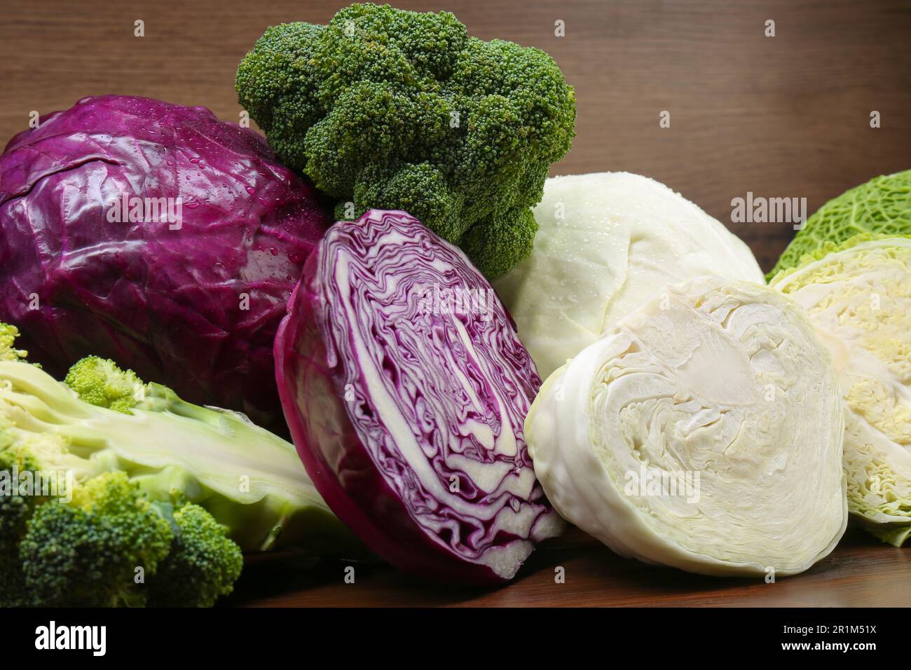 Different types of cabbage on wooden table, closeup Stock Photo - Alamy