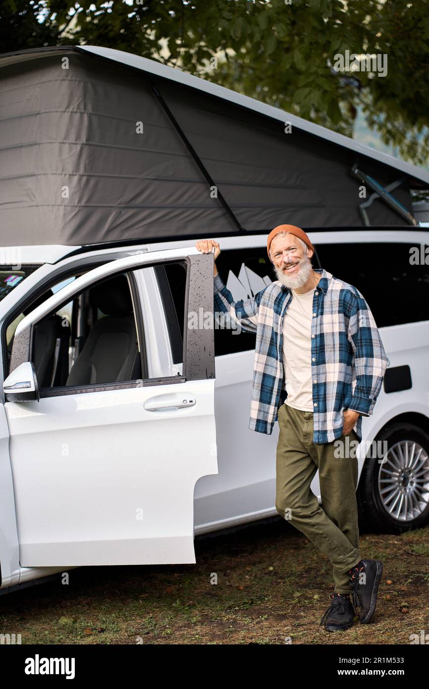 Happy older man traveler standing with camper van, campervan rentals ...