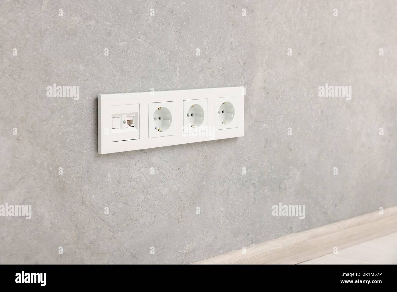 Wall with power outlet sockets in room. Interior design Stock Photo - Alamy