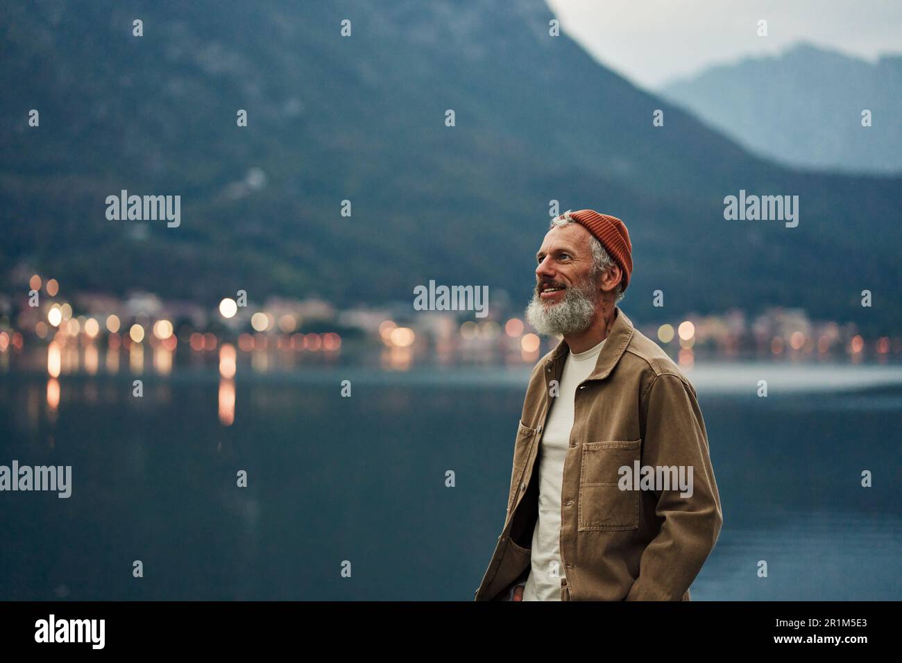 Happy older man standing in nature park enjoying natural landscape ...
