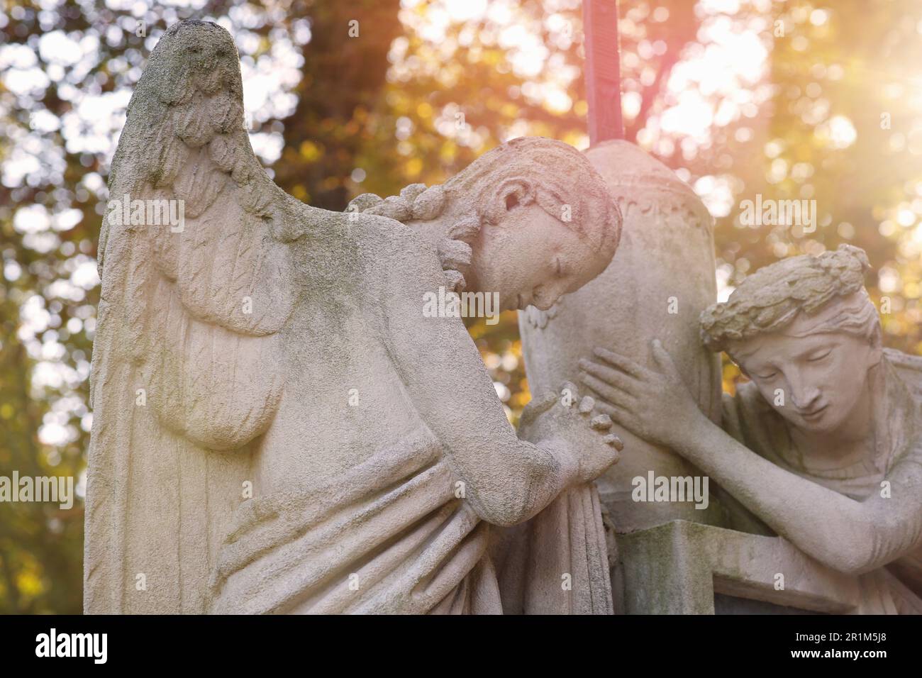 Beautiful statues of angels at cemetery. Religious symbol Stock Photo ...