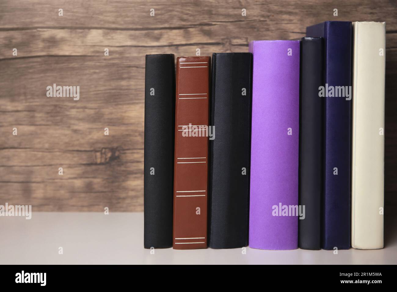 Collection of different books on white shelf, space for text Stock ...