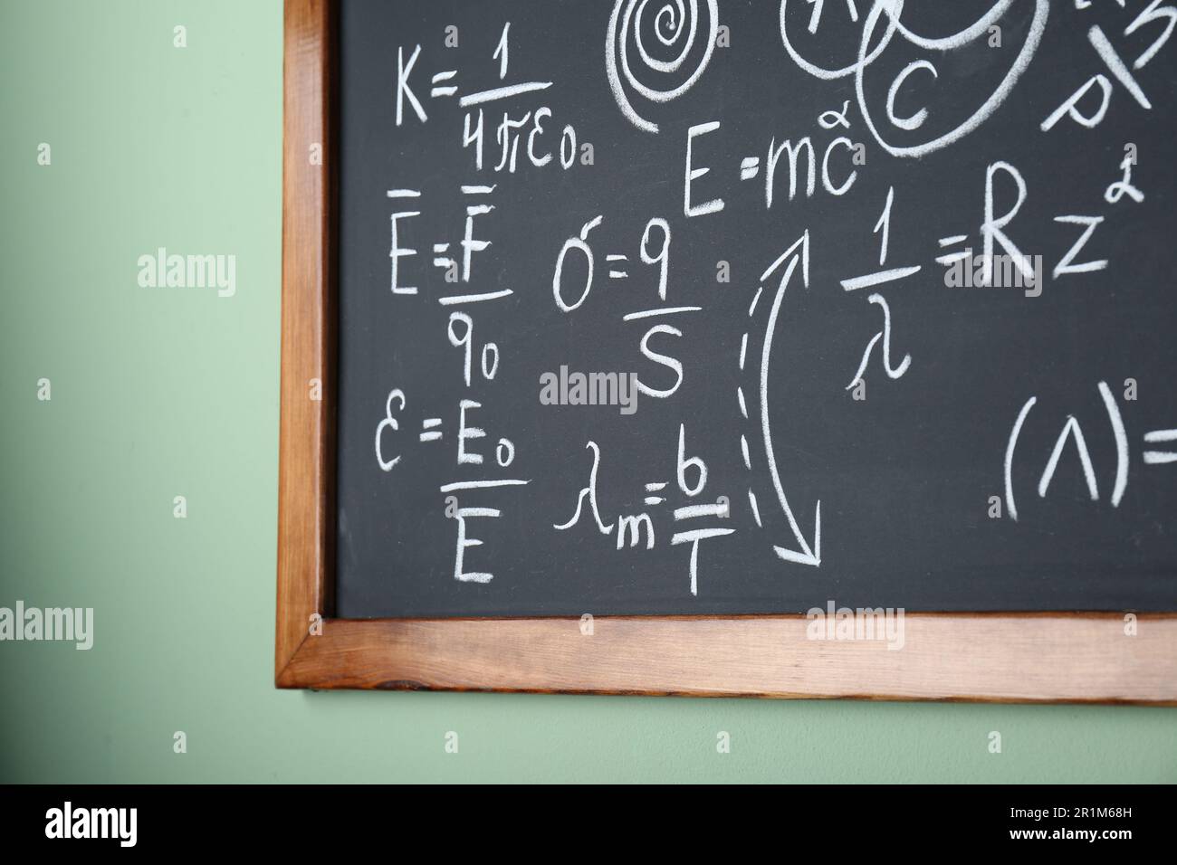Blackboard with different physical formulas written with chalk on light ...