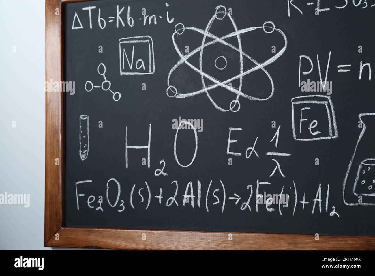 Blackboard with different mathematical formulas written in chalk on ...