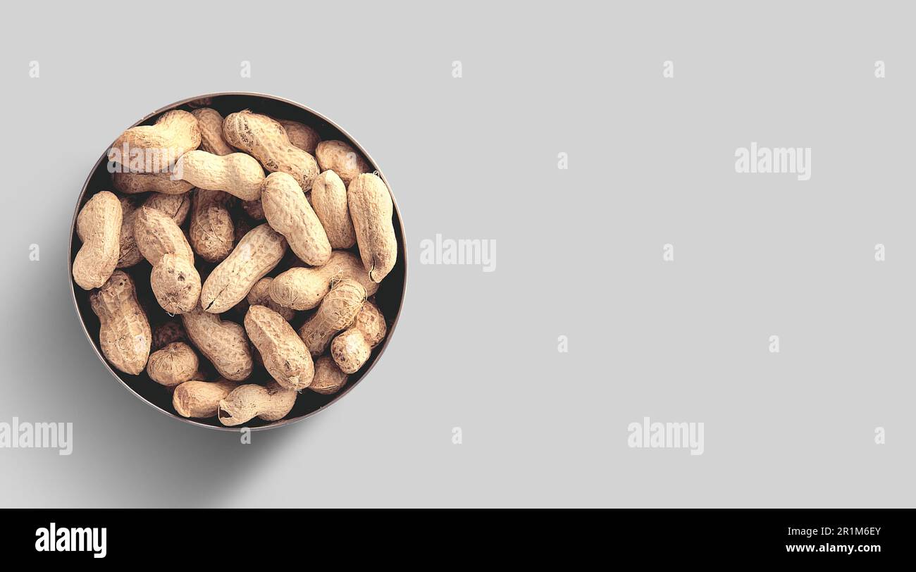 Close up photo of top view peanuts added on ceramic bowl, raw peanuts ...