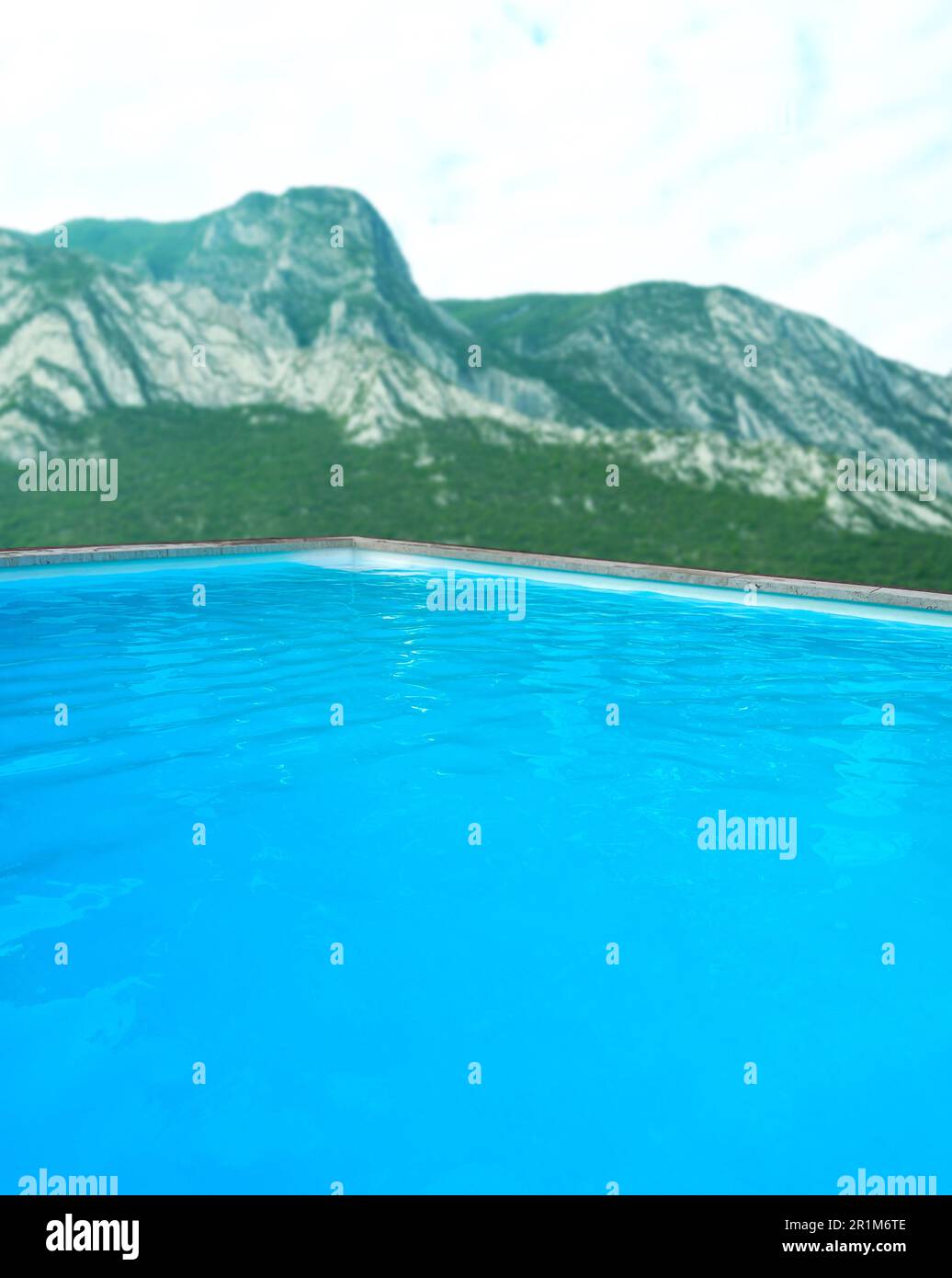 Outdoor swimming pool at luxury resort with beautiful view of mountains ...