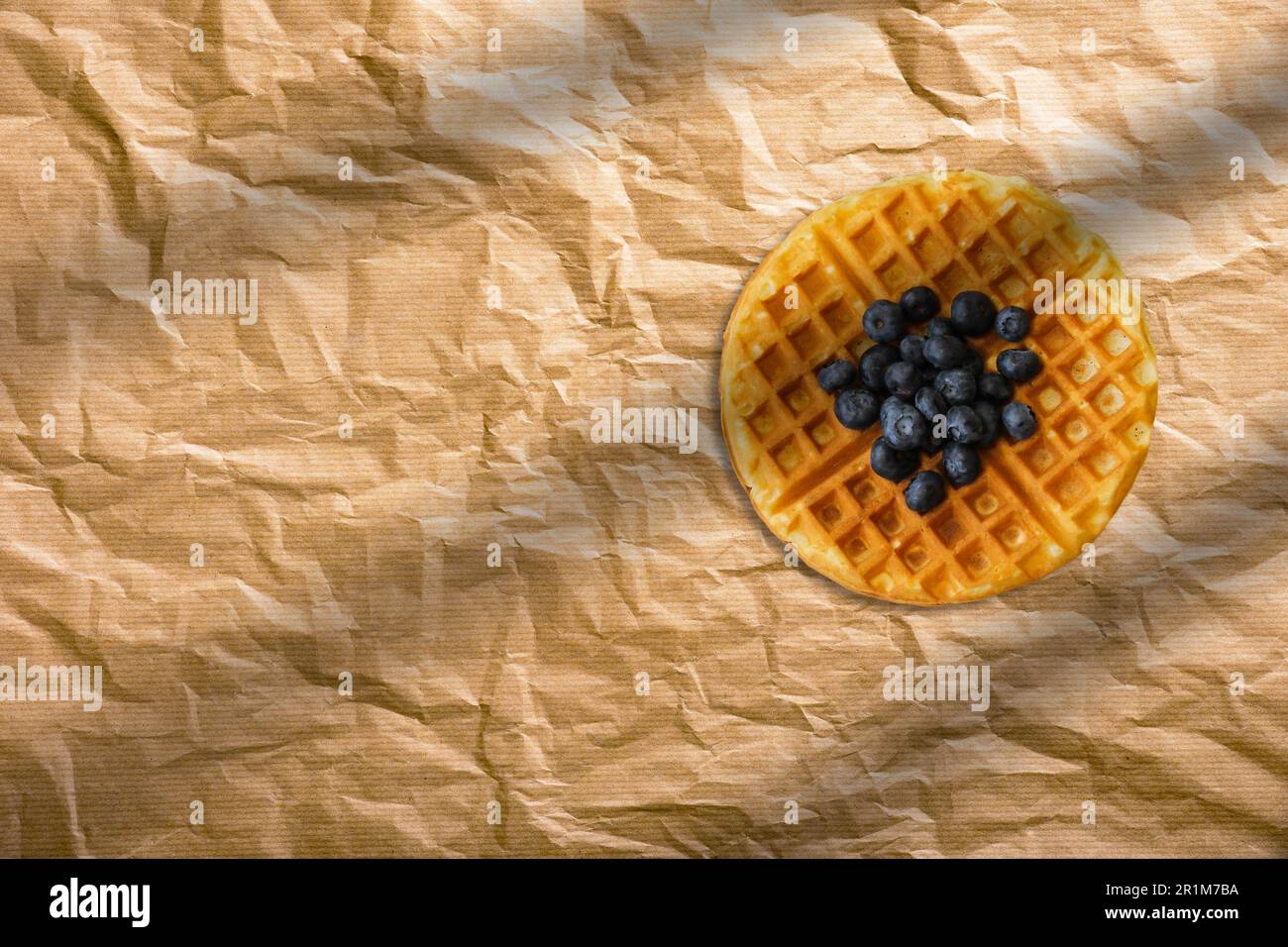 Fresh homemade waffle with blueberry on baking paper. French bakery ...