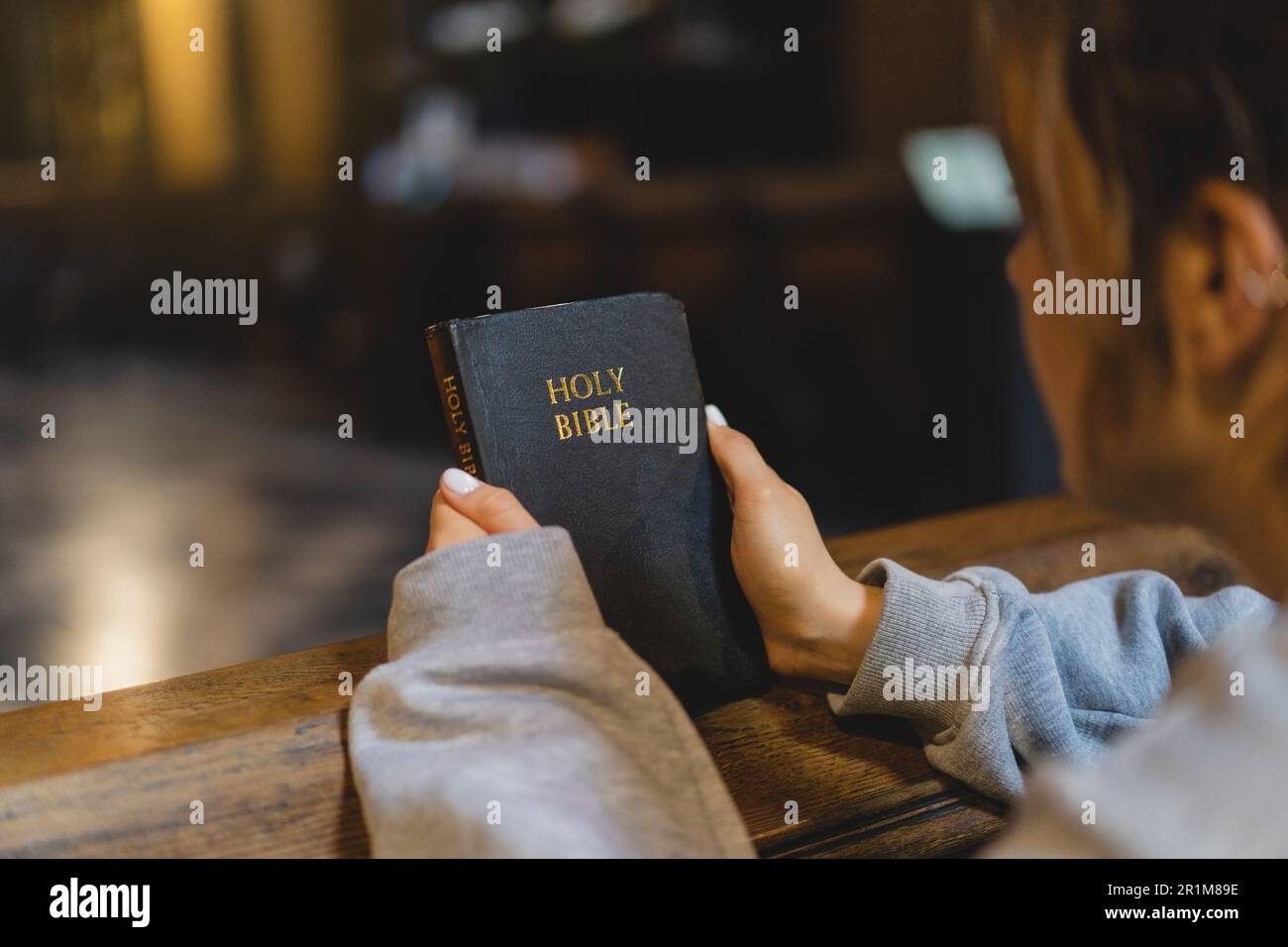 Christian woman reading bible in an ancient Catholic temple. Reading ...