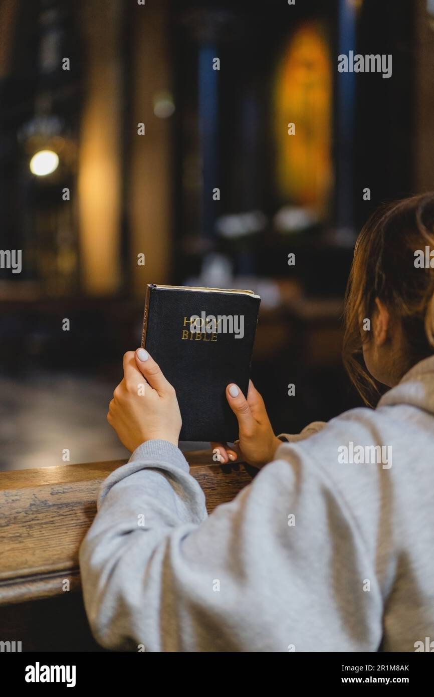 Christian woman reading bible in an ancient Catholic temple. Reading the Holy Bible in temple ...
