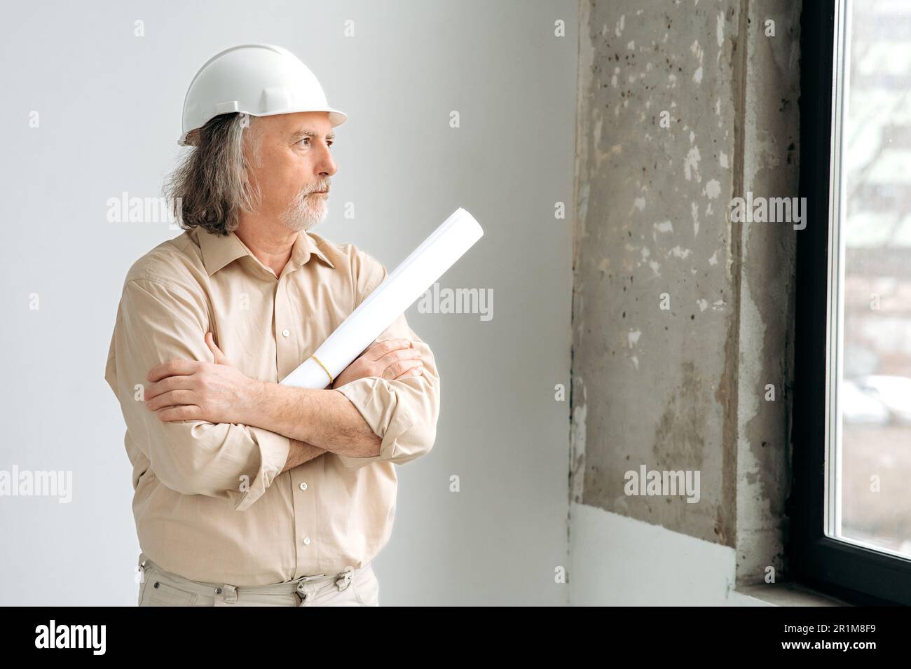 Photo of caucasian mature gray haired male architect builder, civil ...