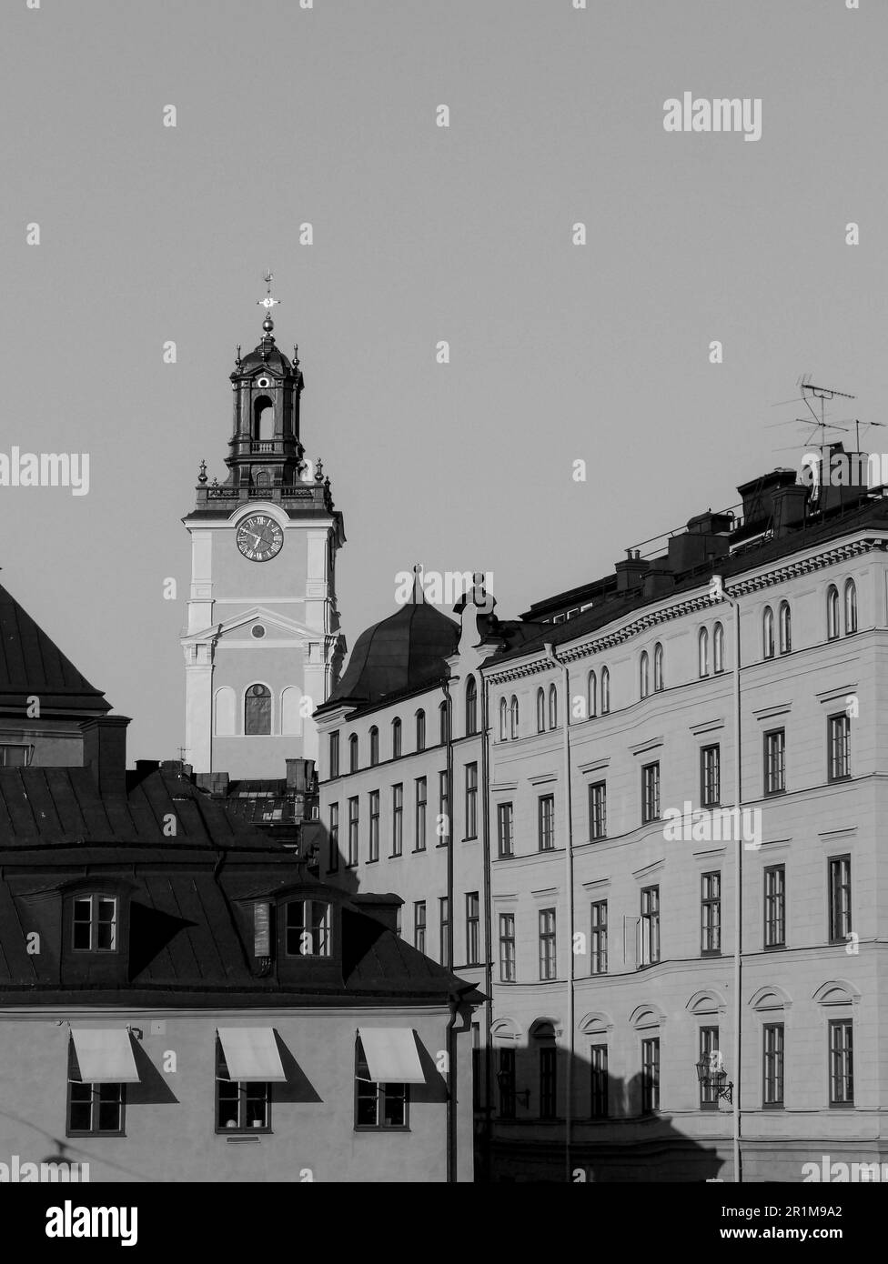 a large clock tower towering over a city Stock Photo - Alamy