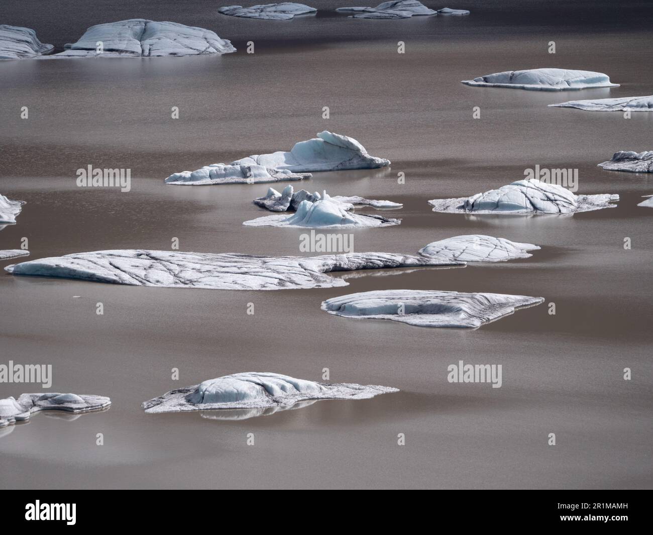 A picturesque scene of a tranquil lake, featuring several large, curved ...