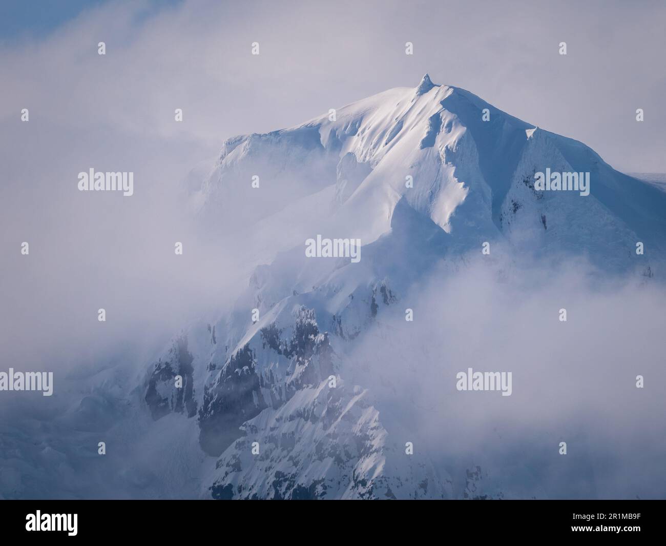 An aerial view of majestic snow-capped mountains with a stunning ...