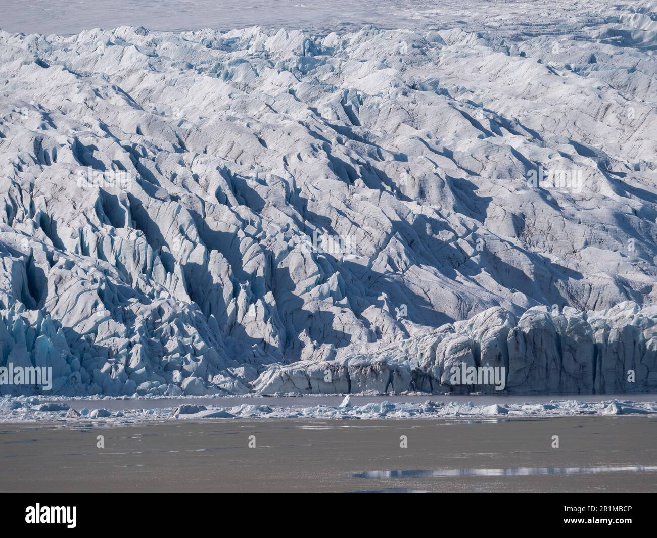 A scenic winter landscape featuring a snow-covered hillside with a ...