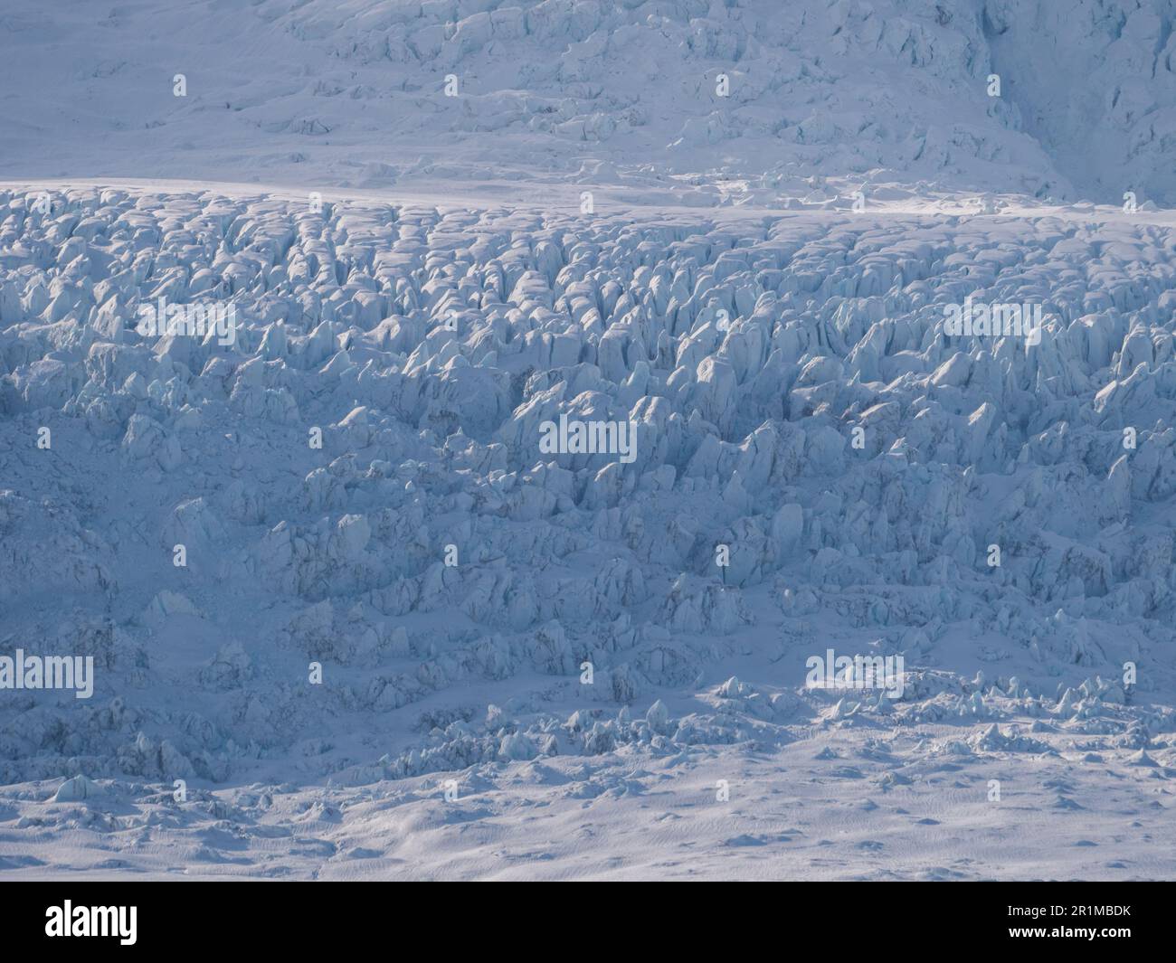 A scenic winter landscape featuring a snow-covered hillside with a ...