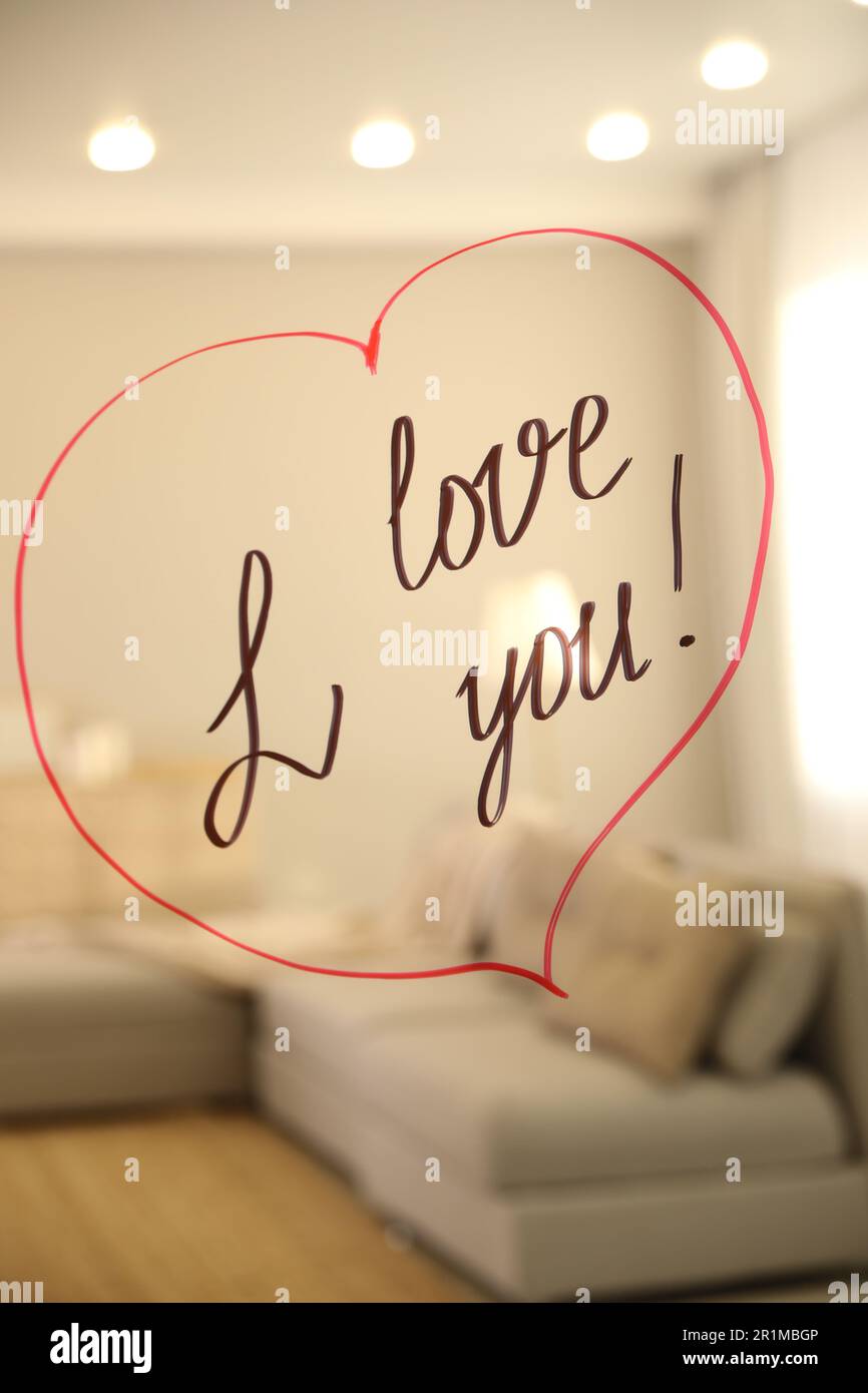 Drawn red heart with handwritten text I Love You on mirror in room ...