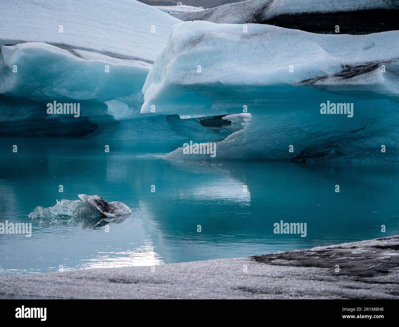 A picturesque landscape of an iceberg in the water with a backdrop of ...