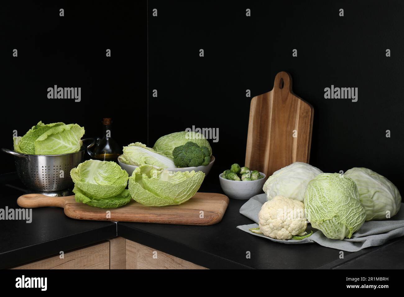 Different types of cabbage on countertop in kitchen Stock Photo - Alamy