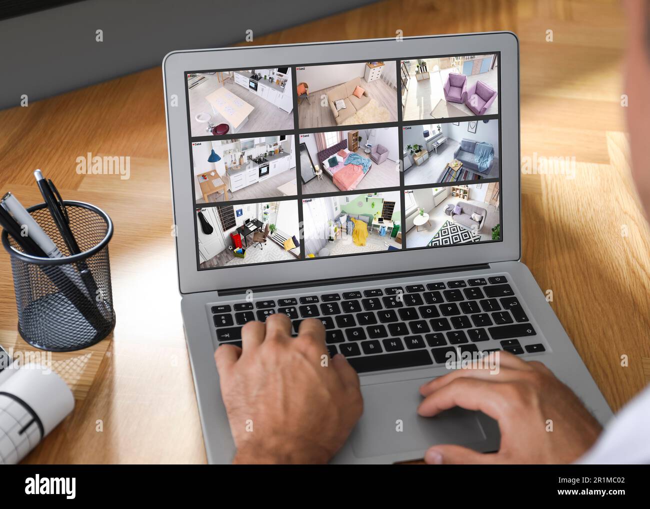 Man monitoring CCTV cameras at table, closeup. Smart home security ...
