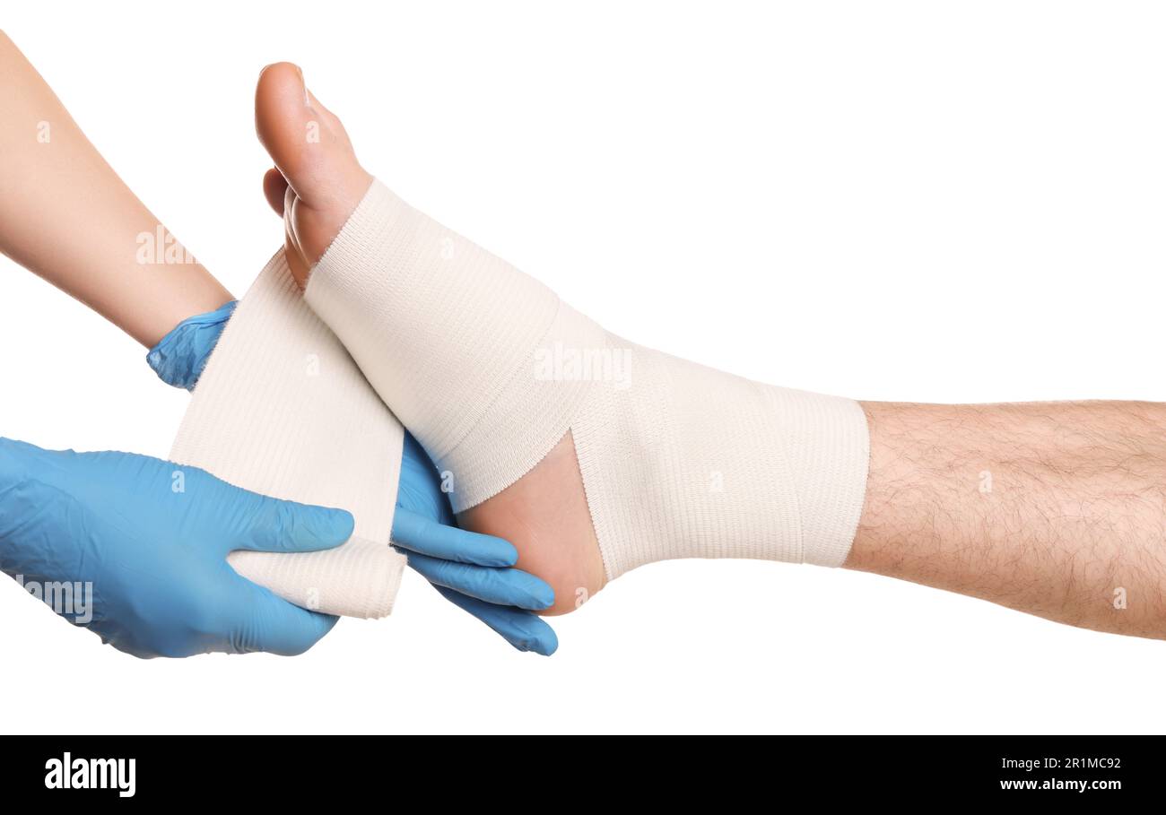 Doctor applying medical bandage onto patient's foot on white background ...