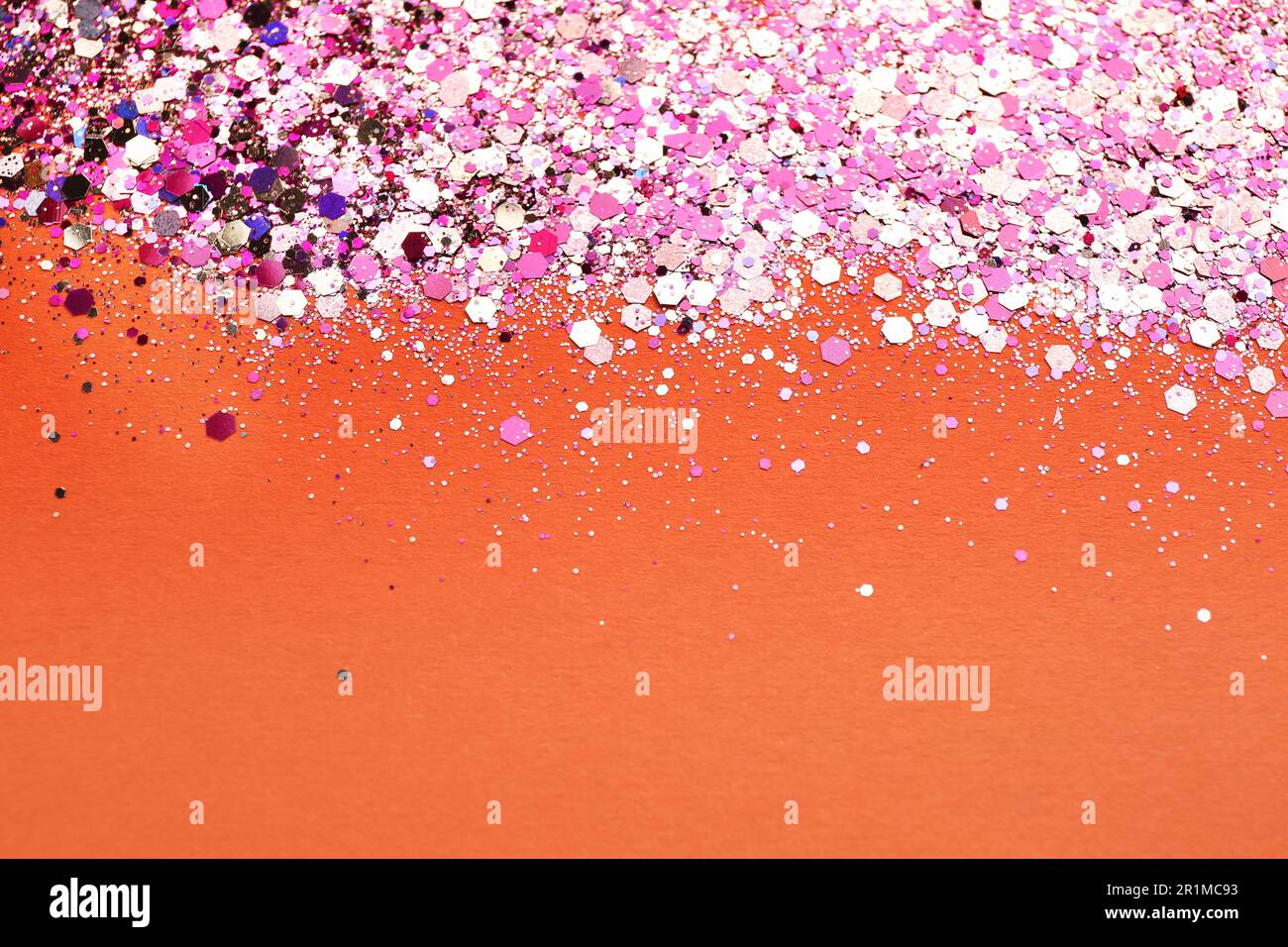 Shiny bright pink glitter on coral background. Space for text Stock ...