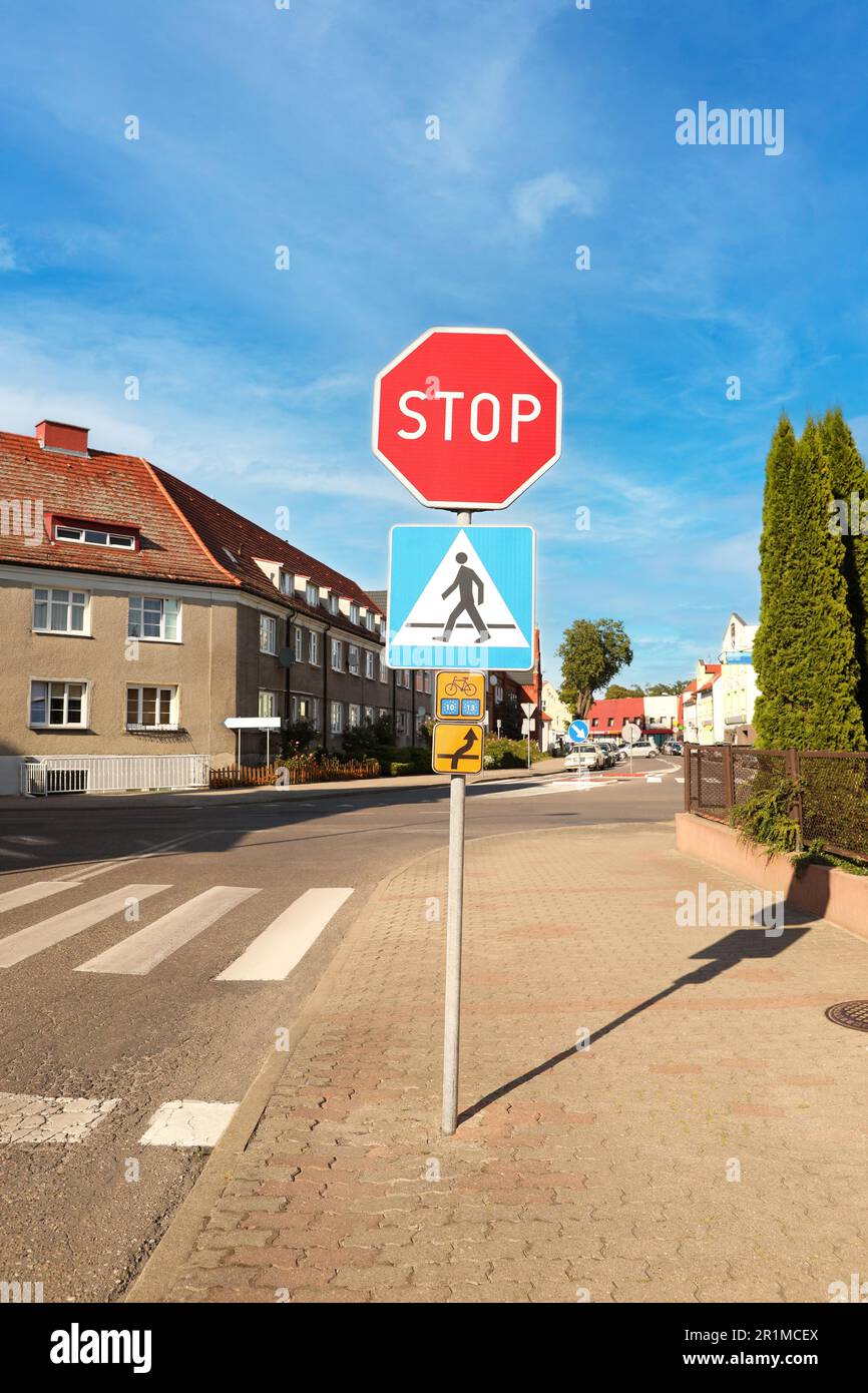 Post with different road signs on city street Stock Photo - Alamy