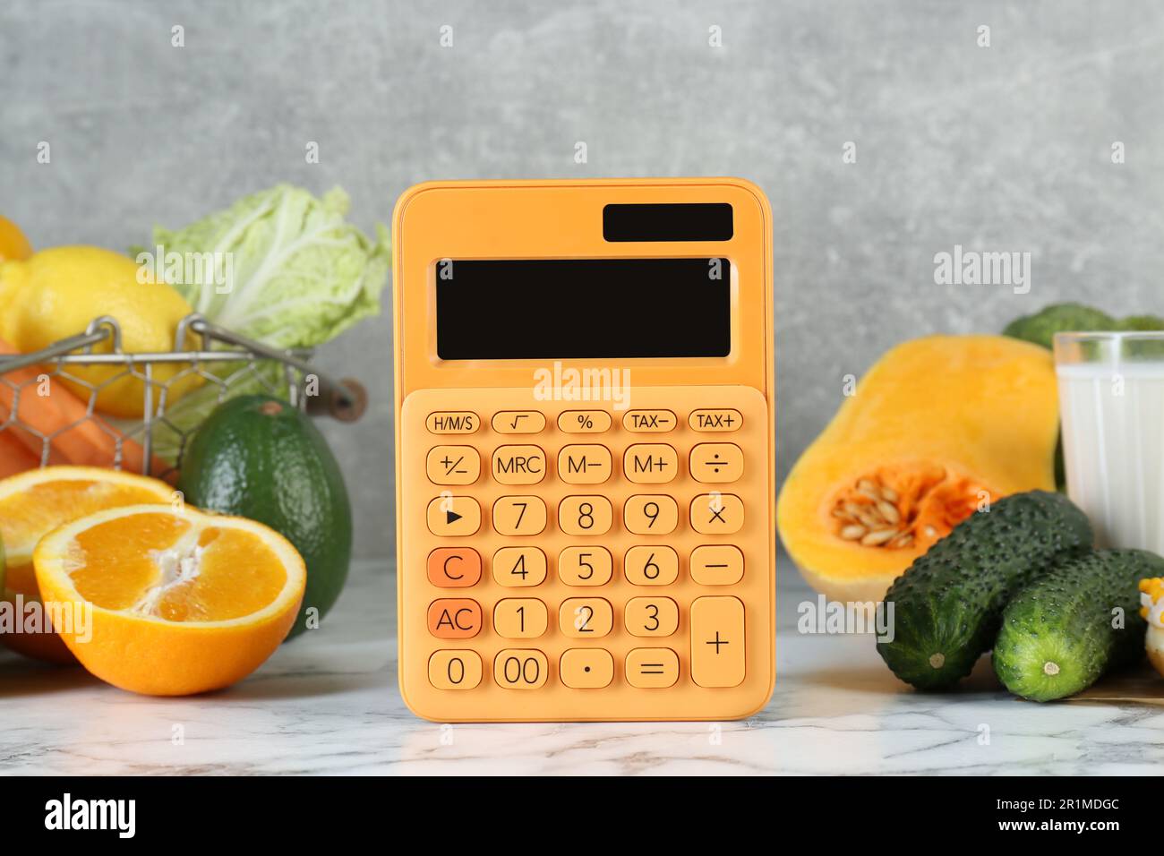 Calculator and food products on white marble table. Weight loss concept ...