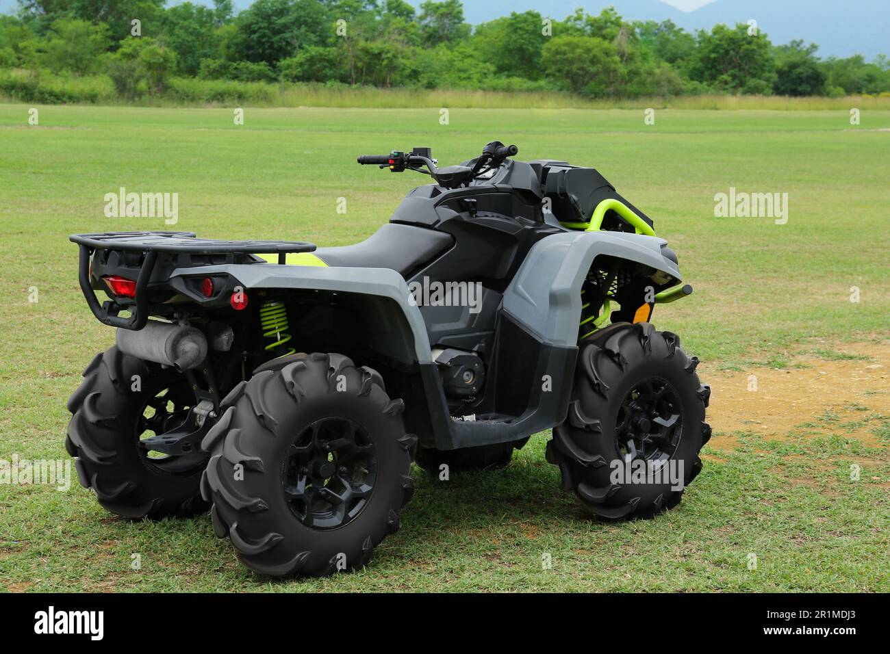 Modern quad bike on green grass outdoors Stock Photo - Alamy
