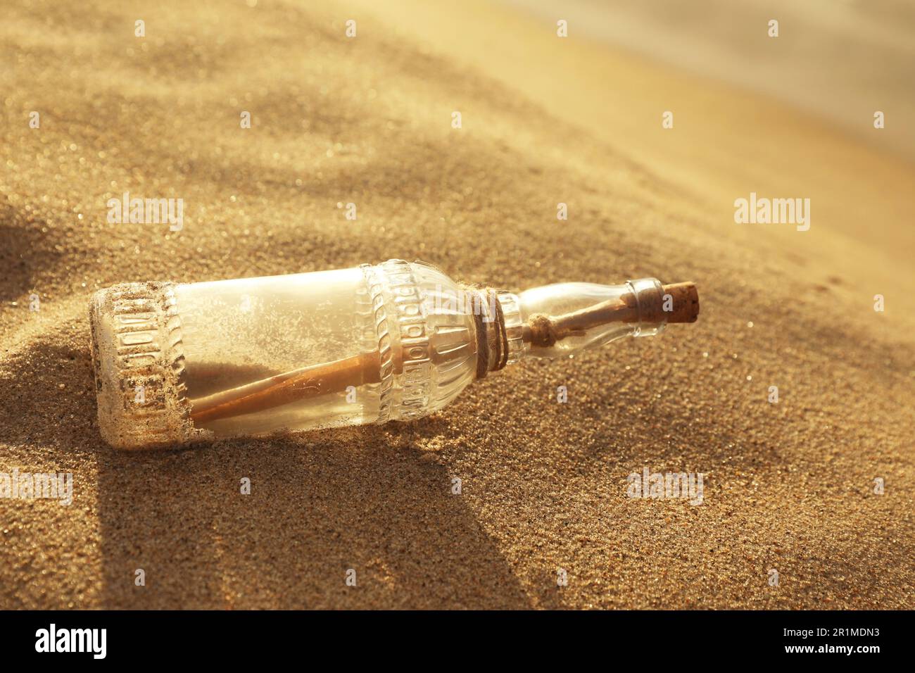 SOS message in glass bottle on sand Stock Photo - Alamy