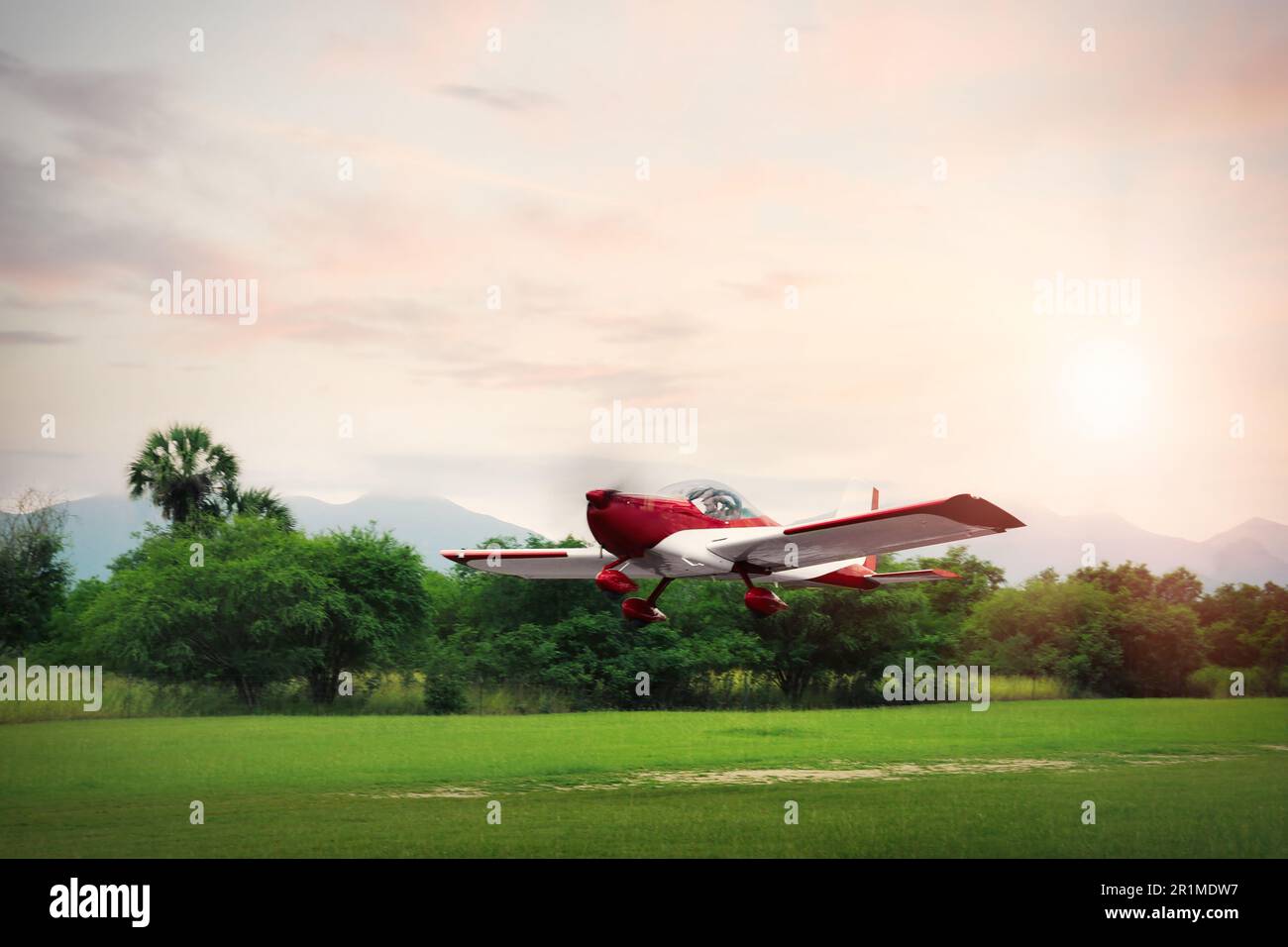 Modern ultralight aircraft flying up from field Stock Photo - Alamy