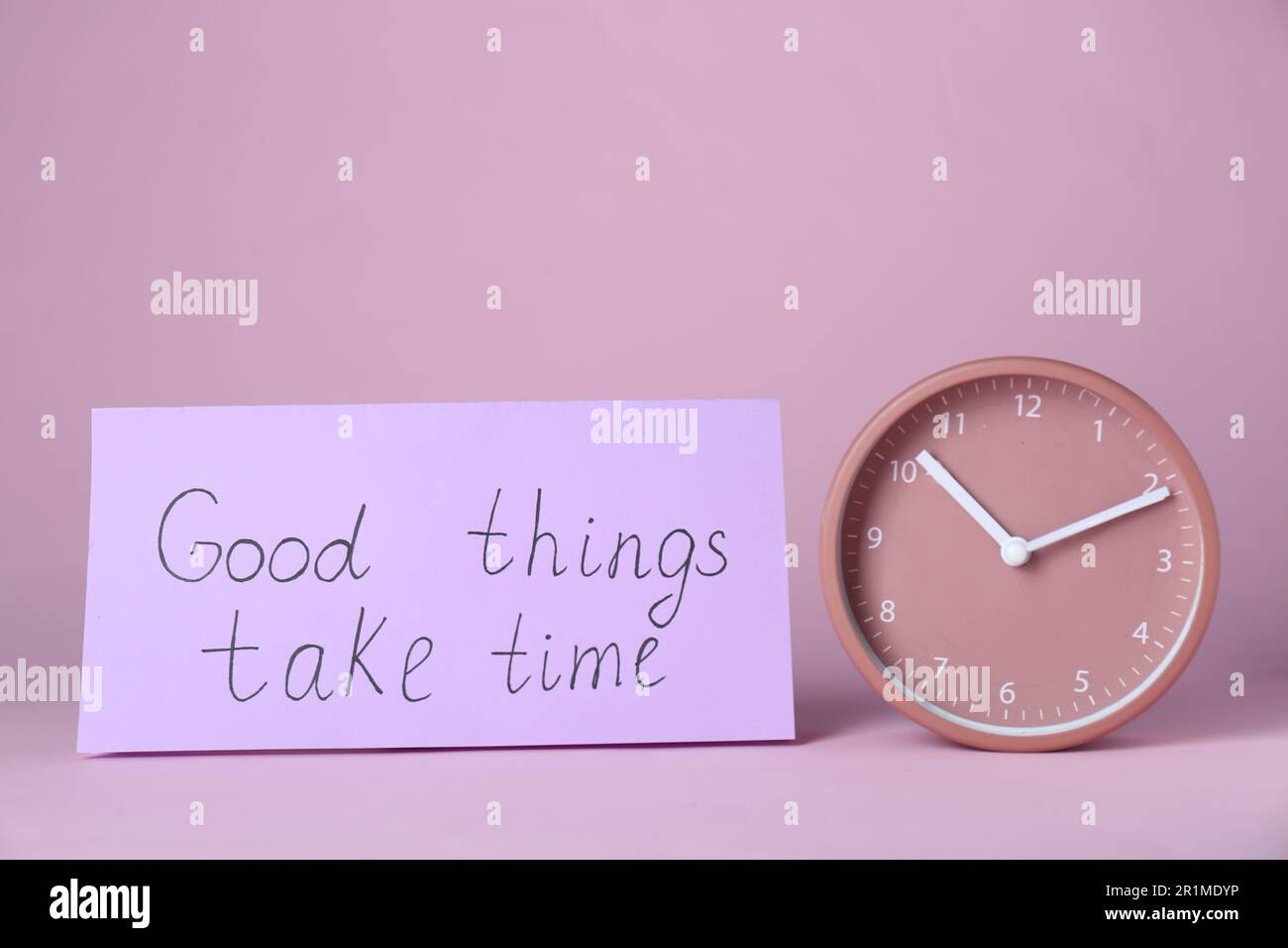 Card with phrase Good Things Take Time and clock on pink background. Motivational quote Stock ...
