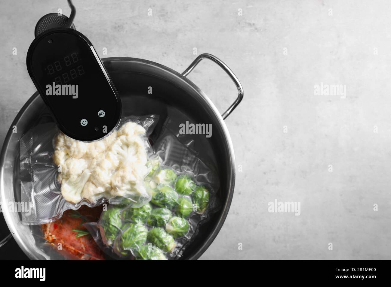 Thermal immersion circulator and vacuum packed ingredients in pot on ...