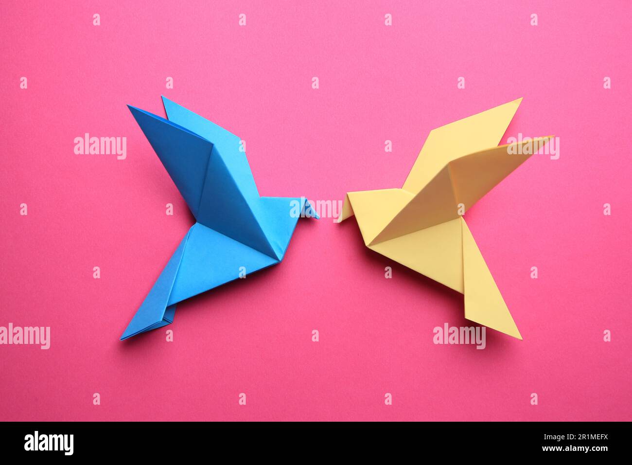 Beautiful colorful origami birds on pink background, flat lay Stock ...