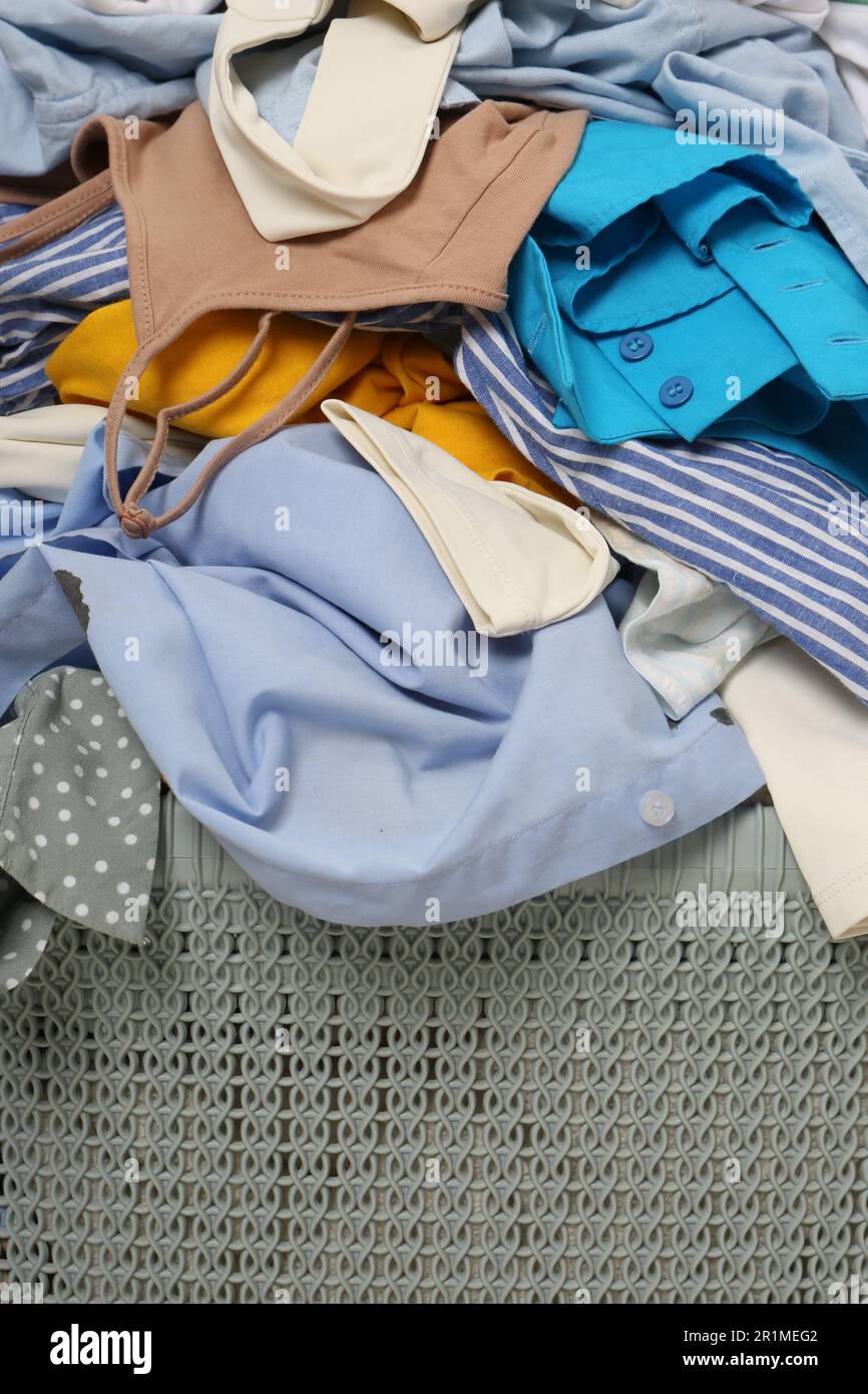 Plastic laundry basket with clothes, closeup view Stock Photo - Alamy